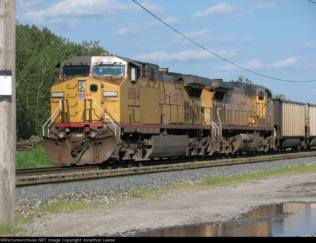 UP 6864 sits with a coal train